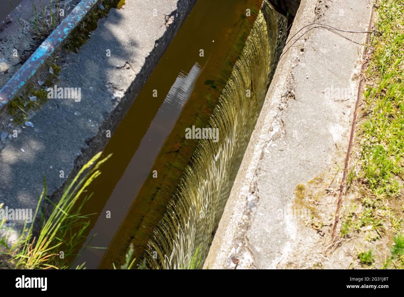 Small waterfall with muddy green water close up Stock Photo - Alamy