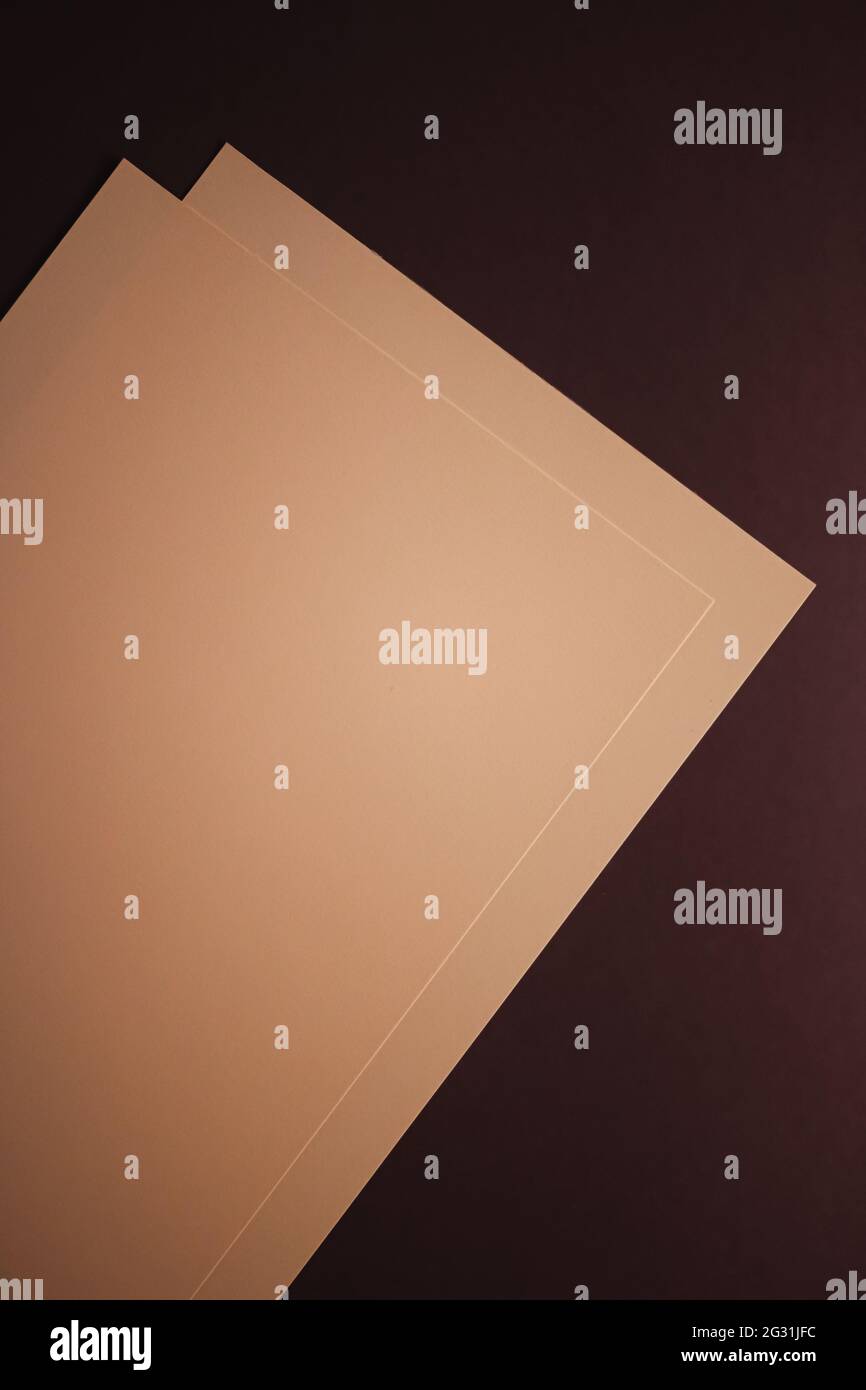 Blank A4 paper, beige on dark background as office stationery flatlay ...