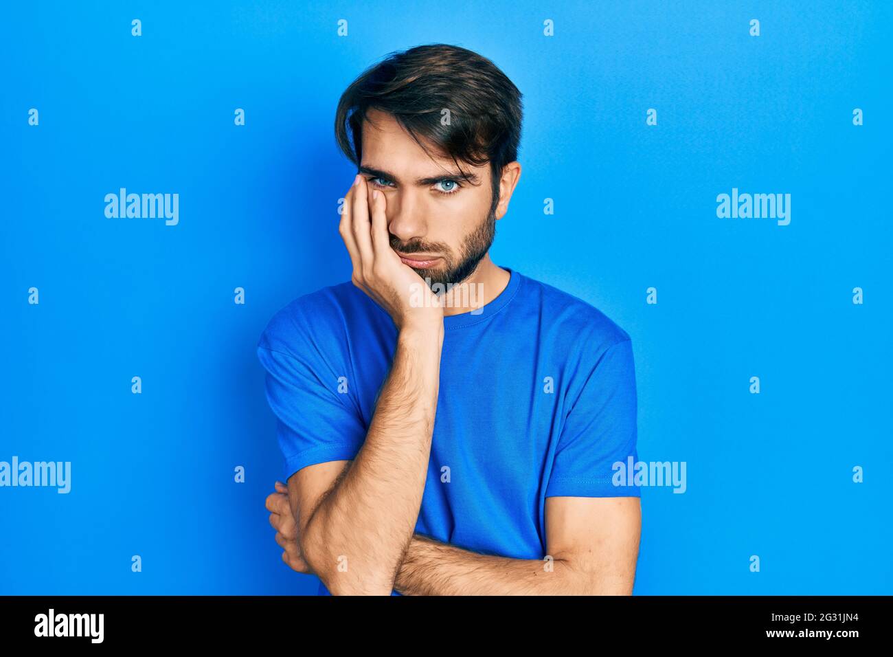 Young hispanic man wearing casual clothes thinking looking tired and ...