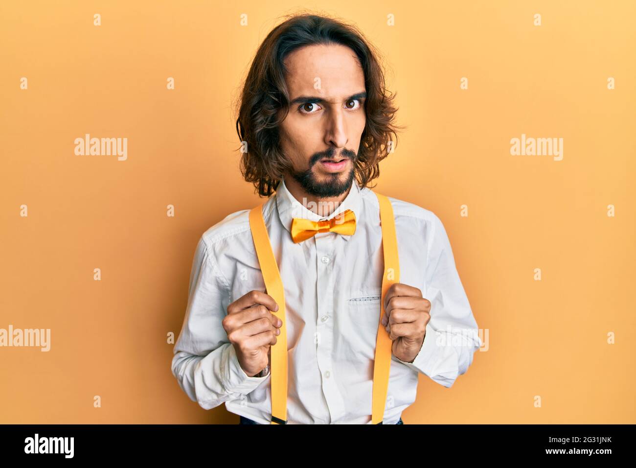 Young hispanic man wearing hipster elegant look in shock face, looking ...