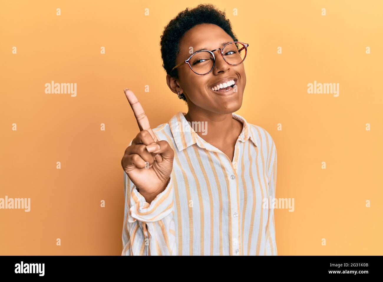 Young african american girl wearing casual clothes and glasses smiling ...