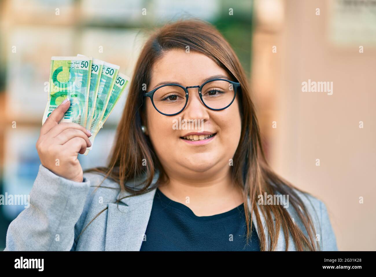 Young hispanic plus size businesswoman smiling happy holding israel ...