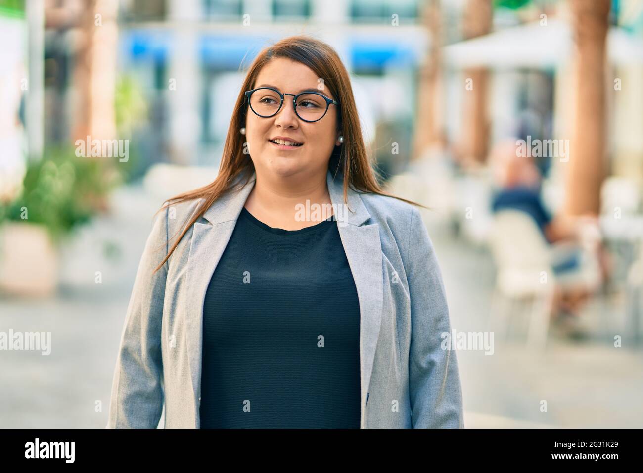 Young hispanic plus size businesswoman smiling happy standing at the ...