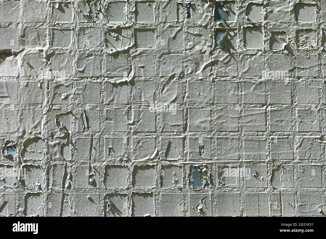 Tiled texture under a layer of white paint. Dirty wall. The texture of ...