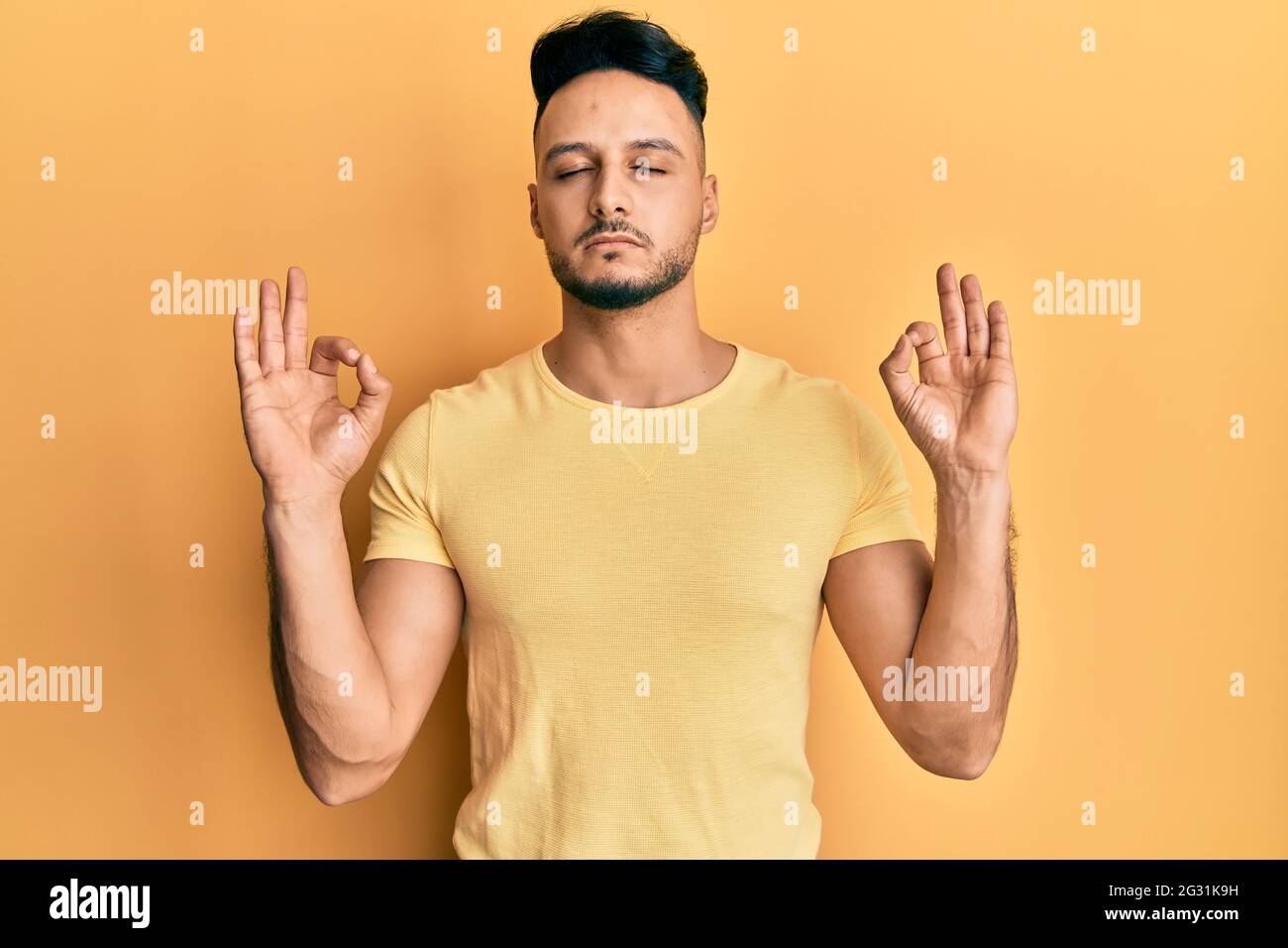 Young arab man wearing casual clothes relax and smiling with eyes ...
