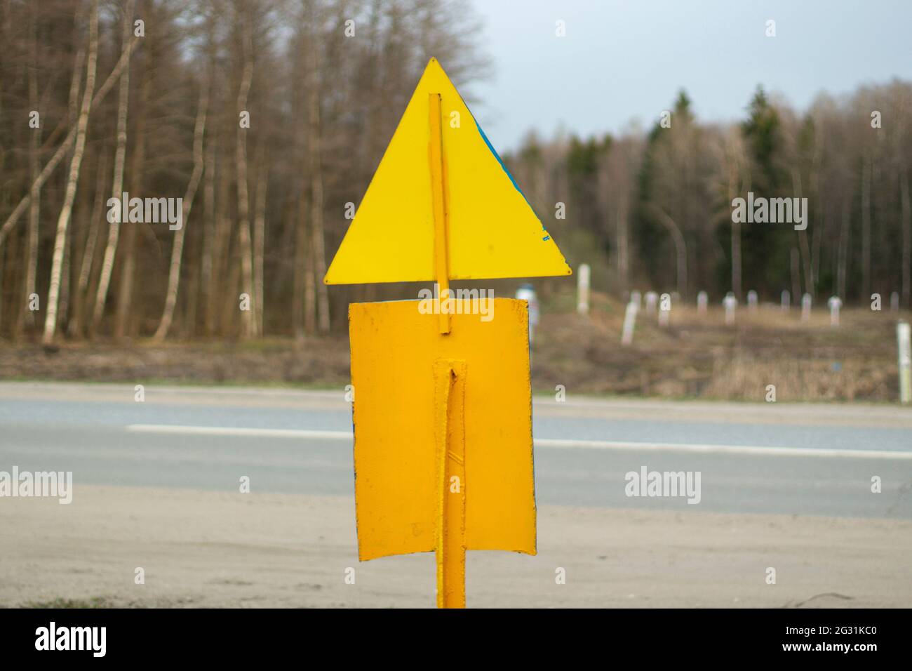 Gas warning yellow sign. Pole in yellow painted metal. Triangular and ...