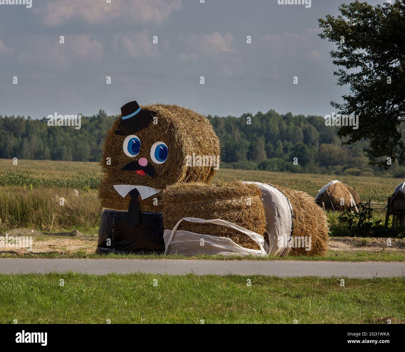 Funny figure of straw after harvest in the village Stock Photo - Alamy