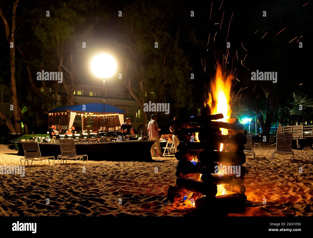 bonfire at a night time buffet table at a caribbean beach resort Stock ...