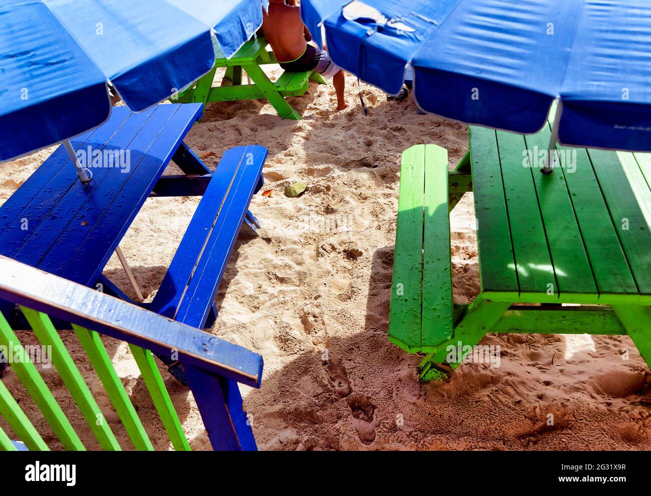 Steps down from a beachside Tiki bar to a picnic area on the beach ...