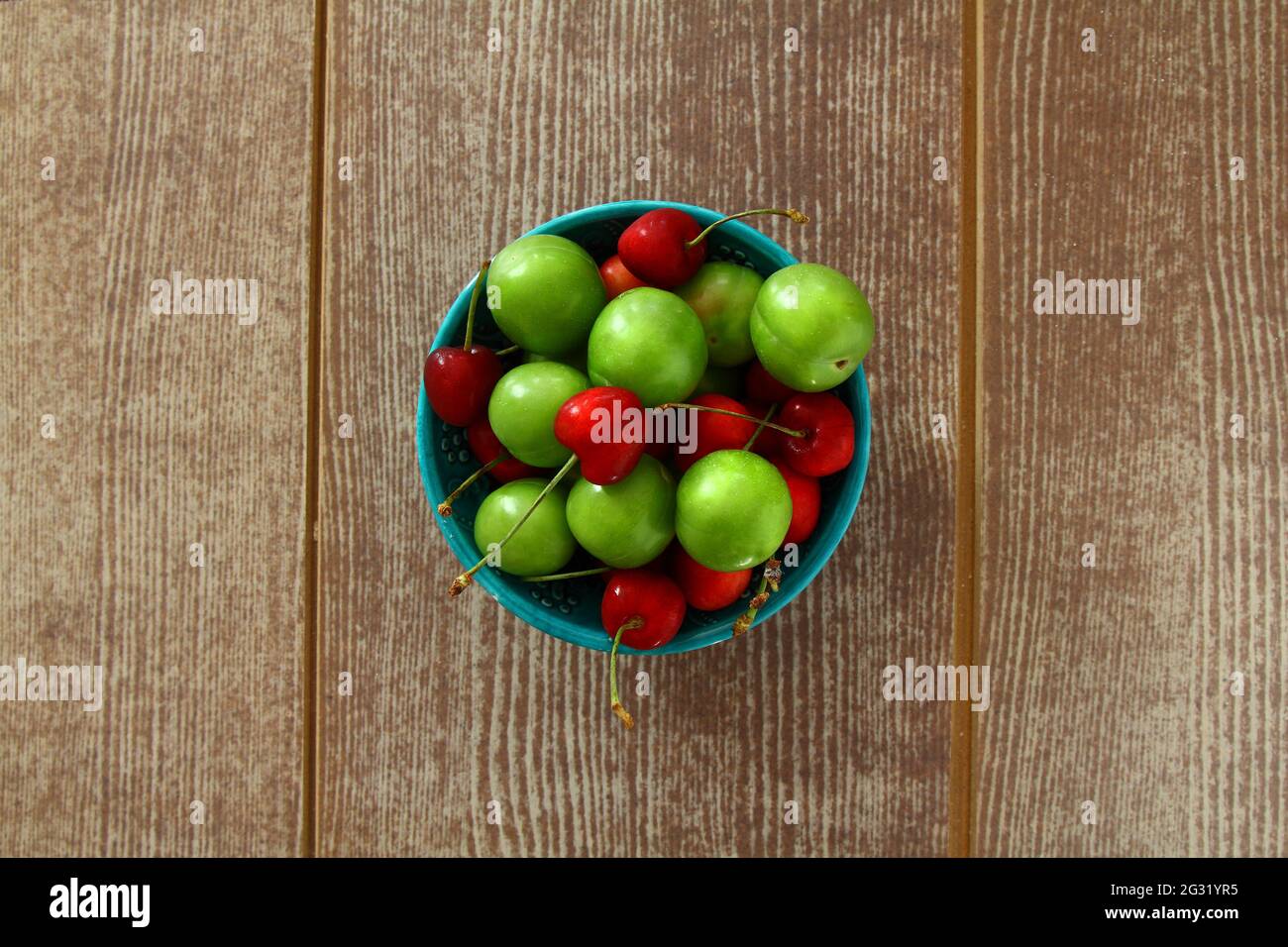 Single whole fresh green Can Erik plum and cherry close up isolated on ...