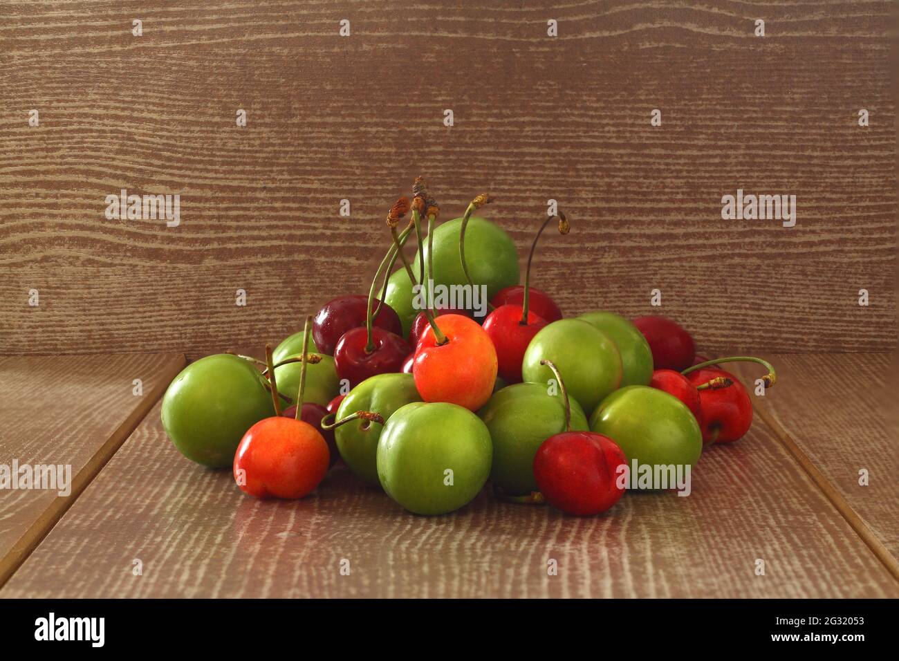 Single whole fresh green Can Erik plum and cherry close up isolated on ...