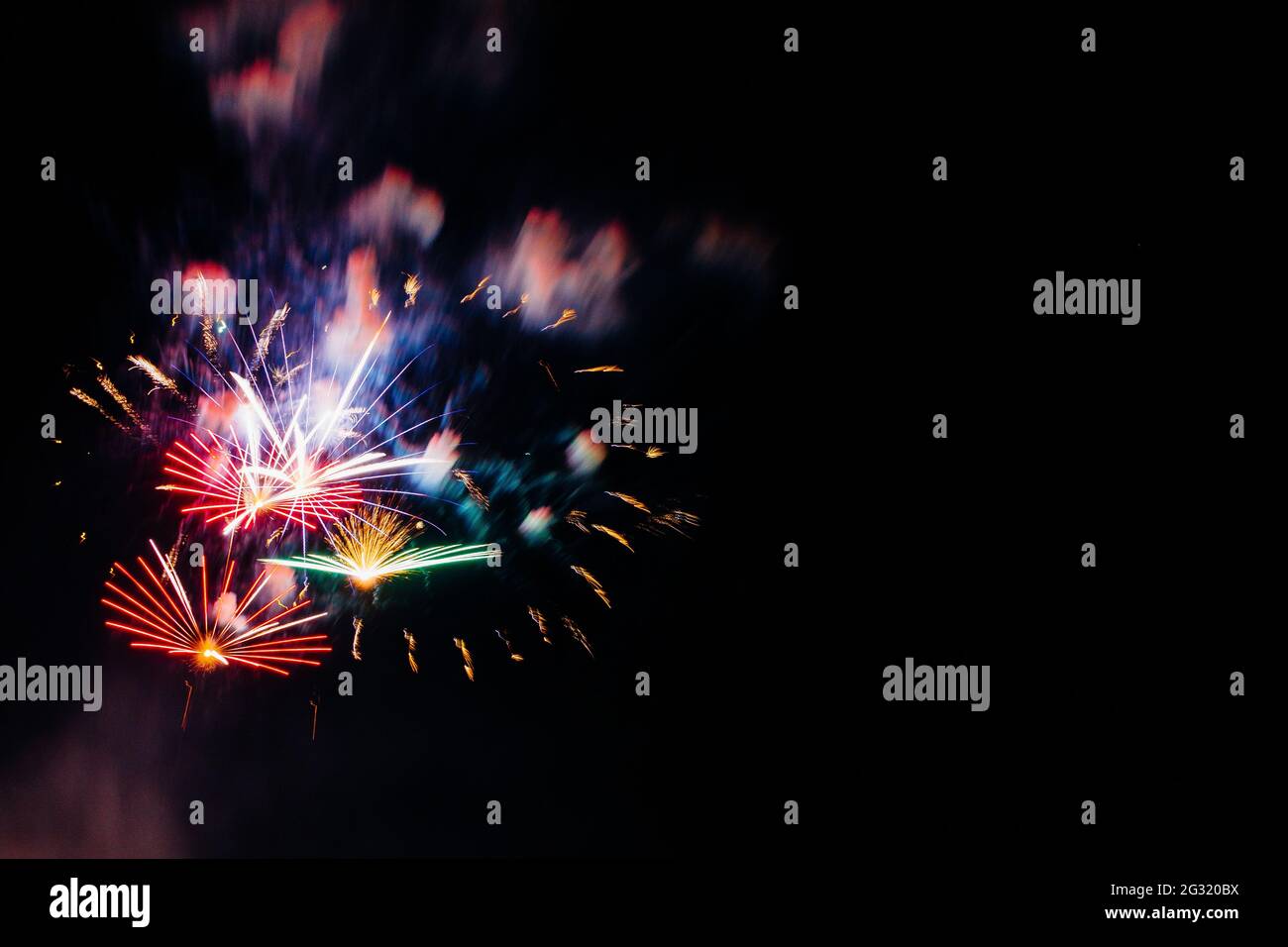 Dark sky with colorful firework blast Stock Photo - Alamy