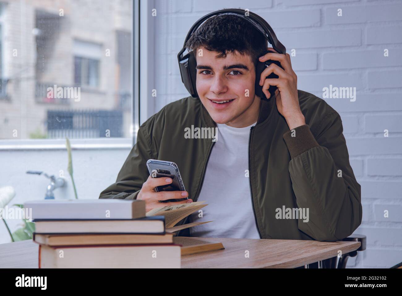 student at home with headphones and mobile phone Stock Photo - Alamy