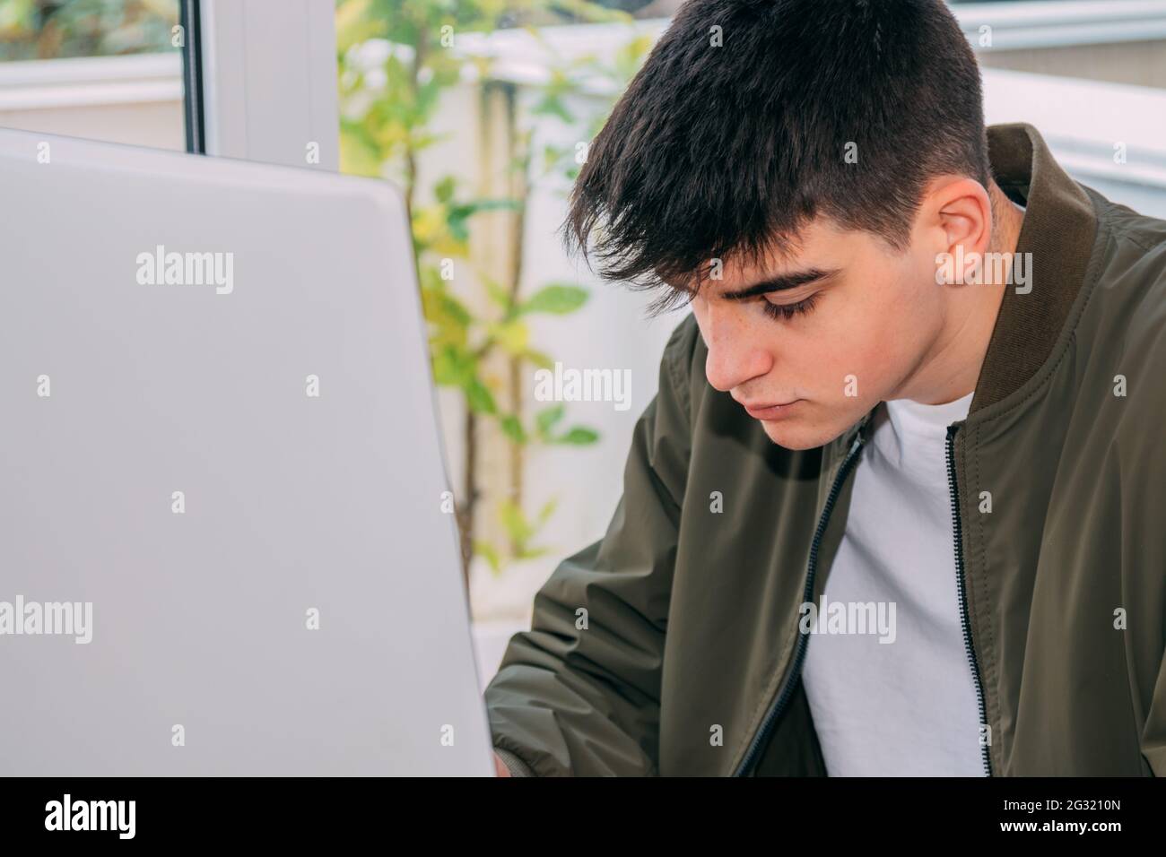 teenage boy with computer working or studying Stock Photo - Alamy