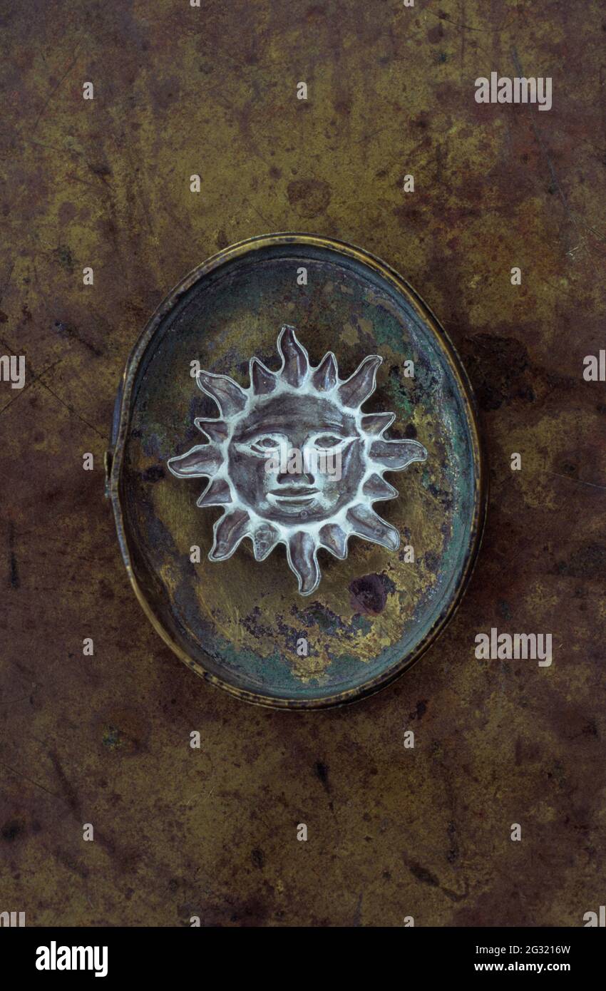 Badge or pin or brooch depicting dark or negative sun with smiling face ...