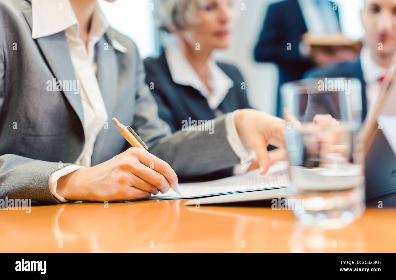 Close-up on woman taking notes during business meeting Stock Photo - Alamy