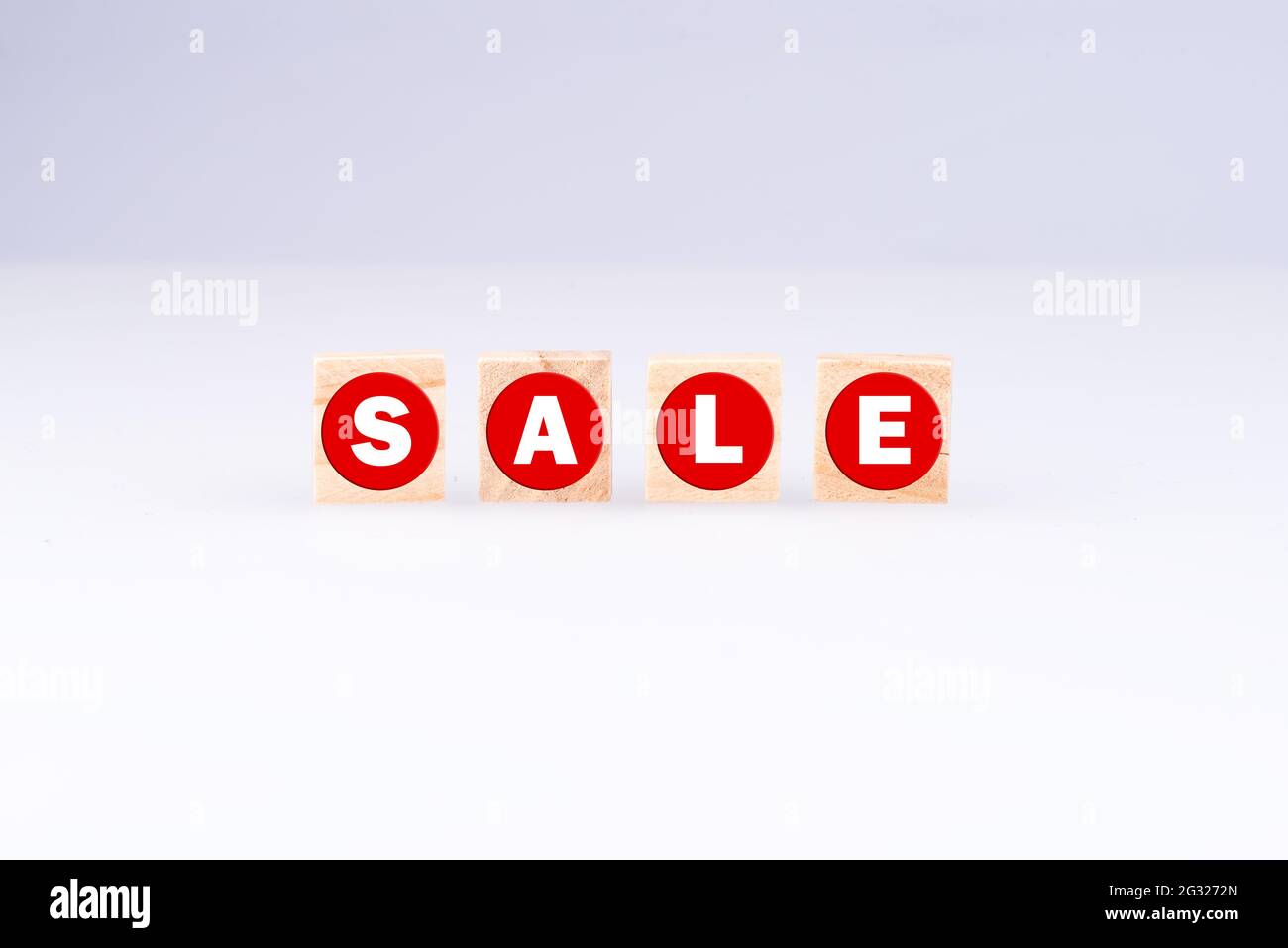 A closeup shot of 4 wooden blocks with the word sale isolated on a ...