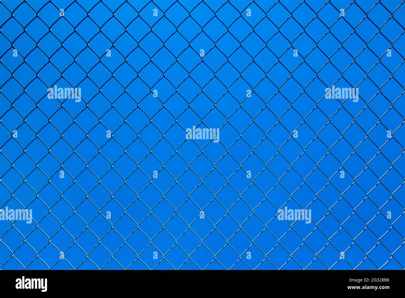Wire mesh fence with a blue sky Stock Photo - Alamy