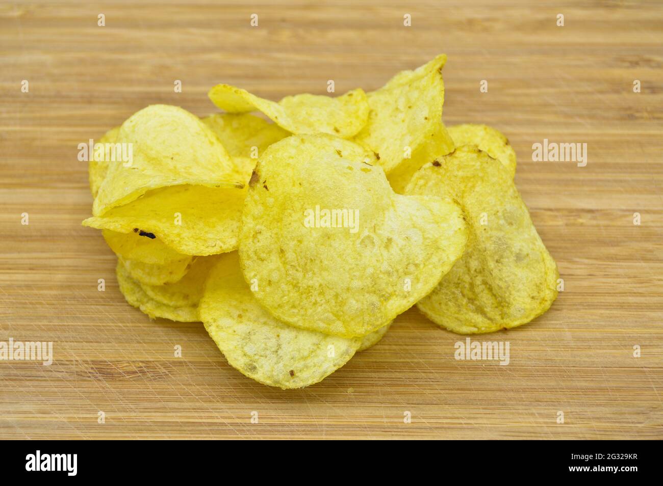 Homemade fresh and fried potatoes, crisps on cutting board, golden ...