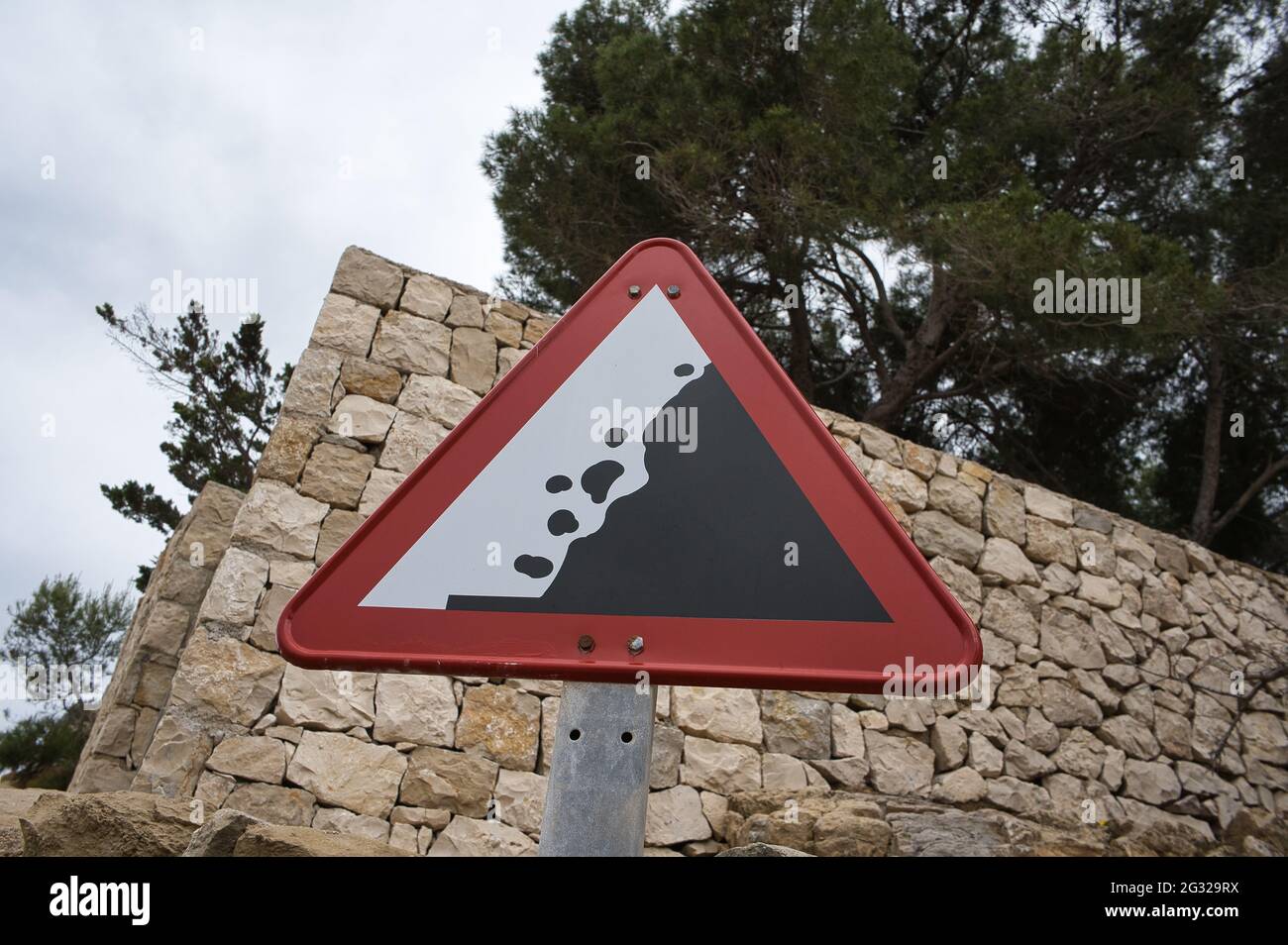 cave-in danger sign with stones and trees behind. view Stock Photo - Alamy