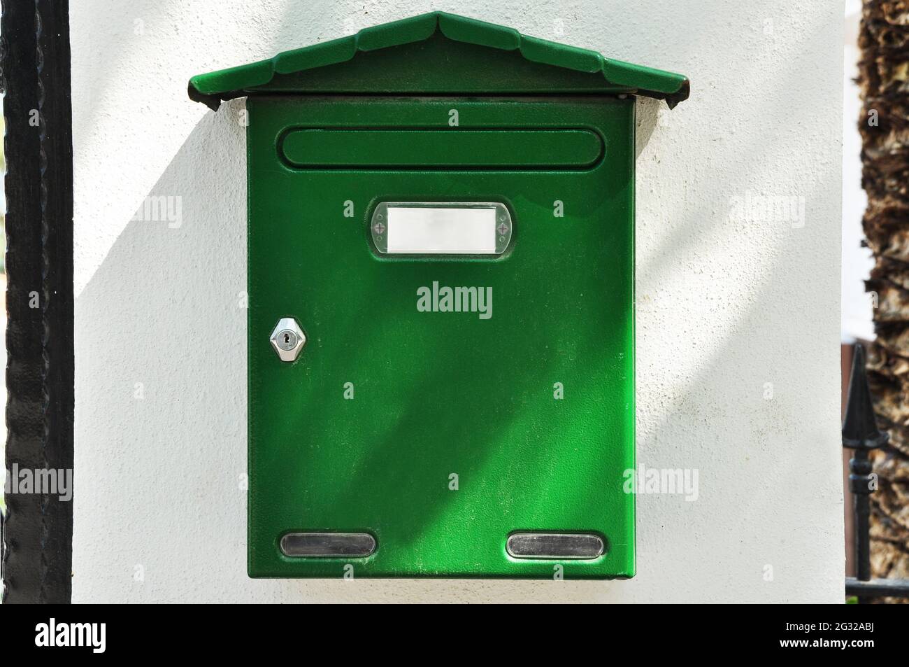 Vintage metal green mailbox near the entrance door of a luxury house ...