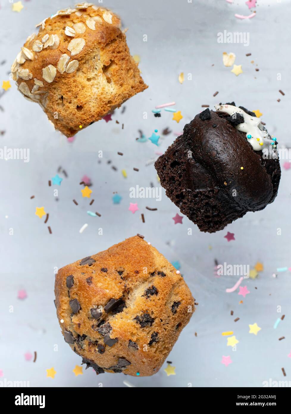 Variety of muffins with sprinkles floating Stock Photo - Alamy