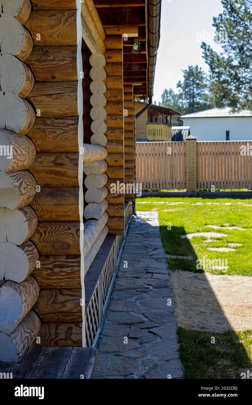 The facade of the modern wooden house made of round logs. Comfortable ...
