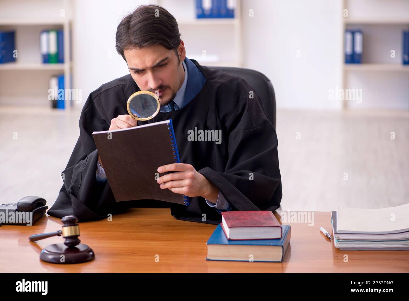 Young judge working in the courtroom Stock Photo - Alamy