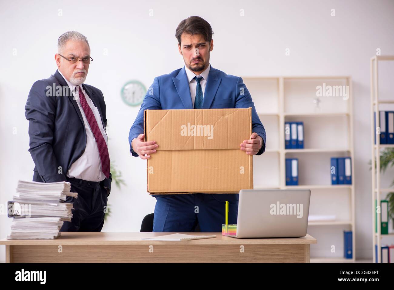 Two employees in dismissal concept Stock Photo - Alamy