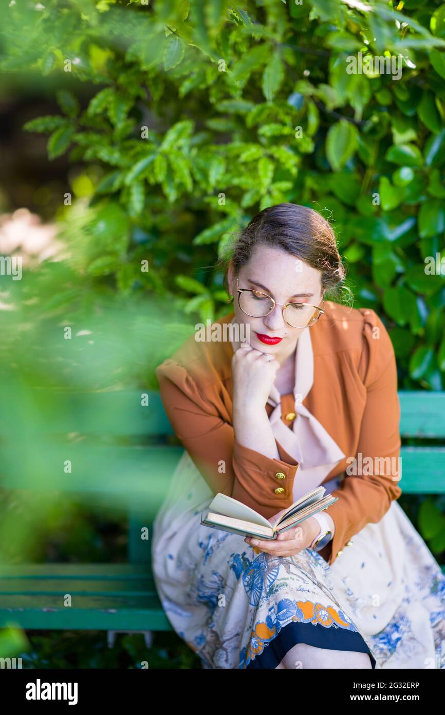 Young Intellectual Woman Dressed in 1940s Clothing In a Garden Stock ...