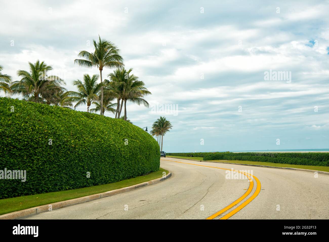Seaside highway along bush fence on cloudy outdoors in Palm Beach ...