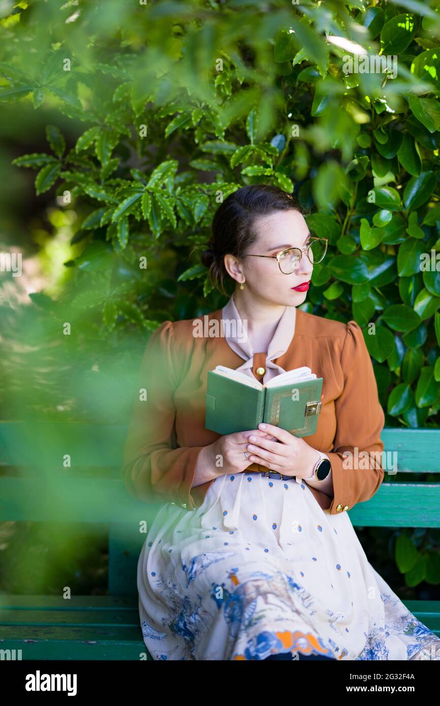 Young Intellectual Woman Dressed in 1940s Clothing In a Garden Stock ...