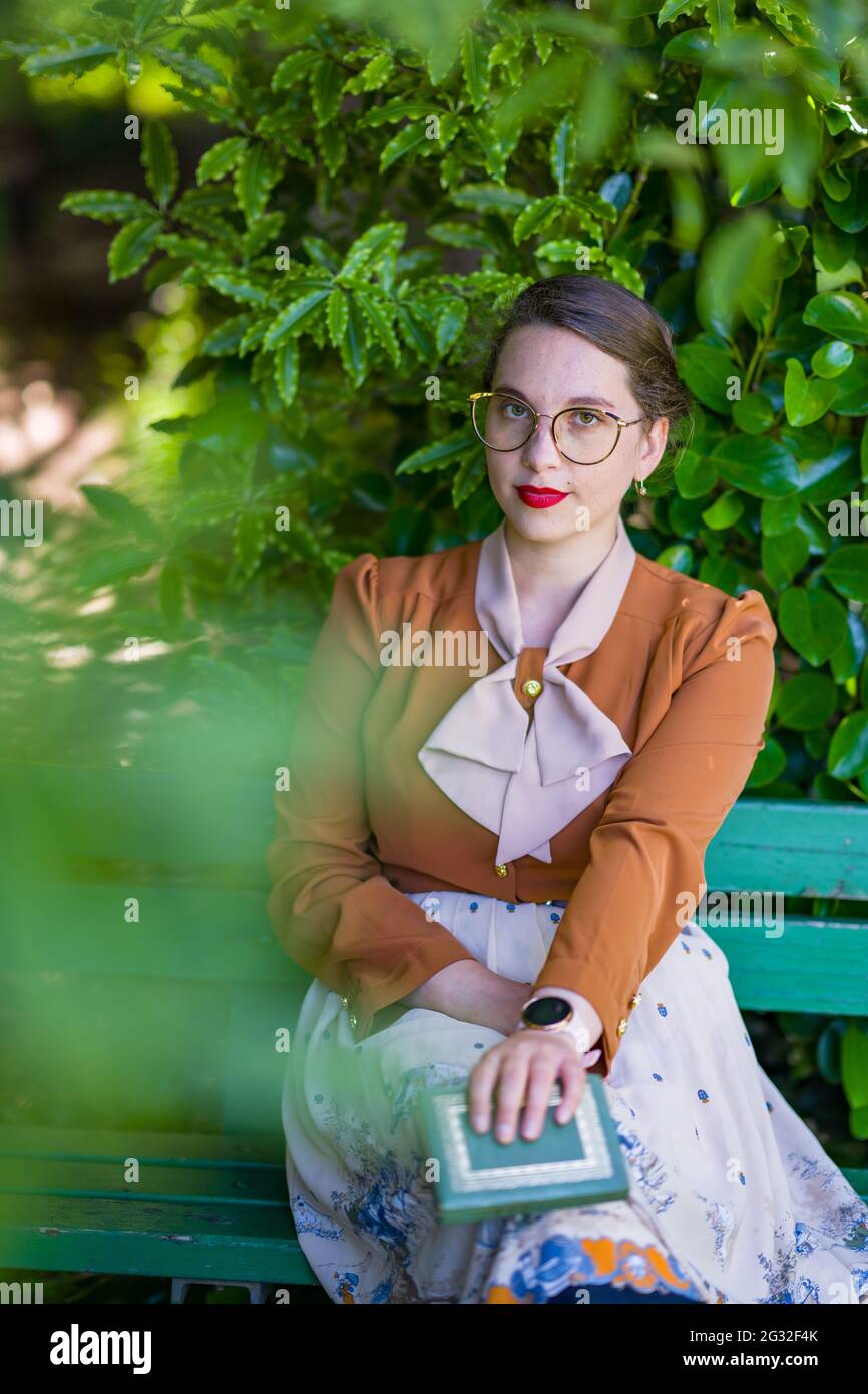 Young Intellectual Woman Dressed in 1940s Clothing In a Garden Stock ...