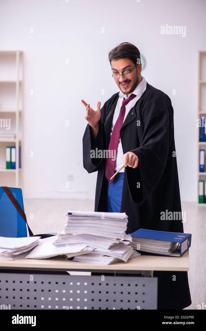 Funny young employee magician and too much work in the office Stock ...