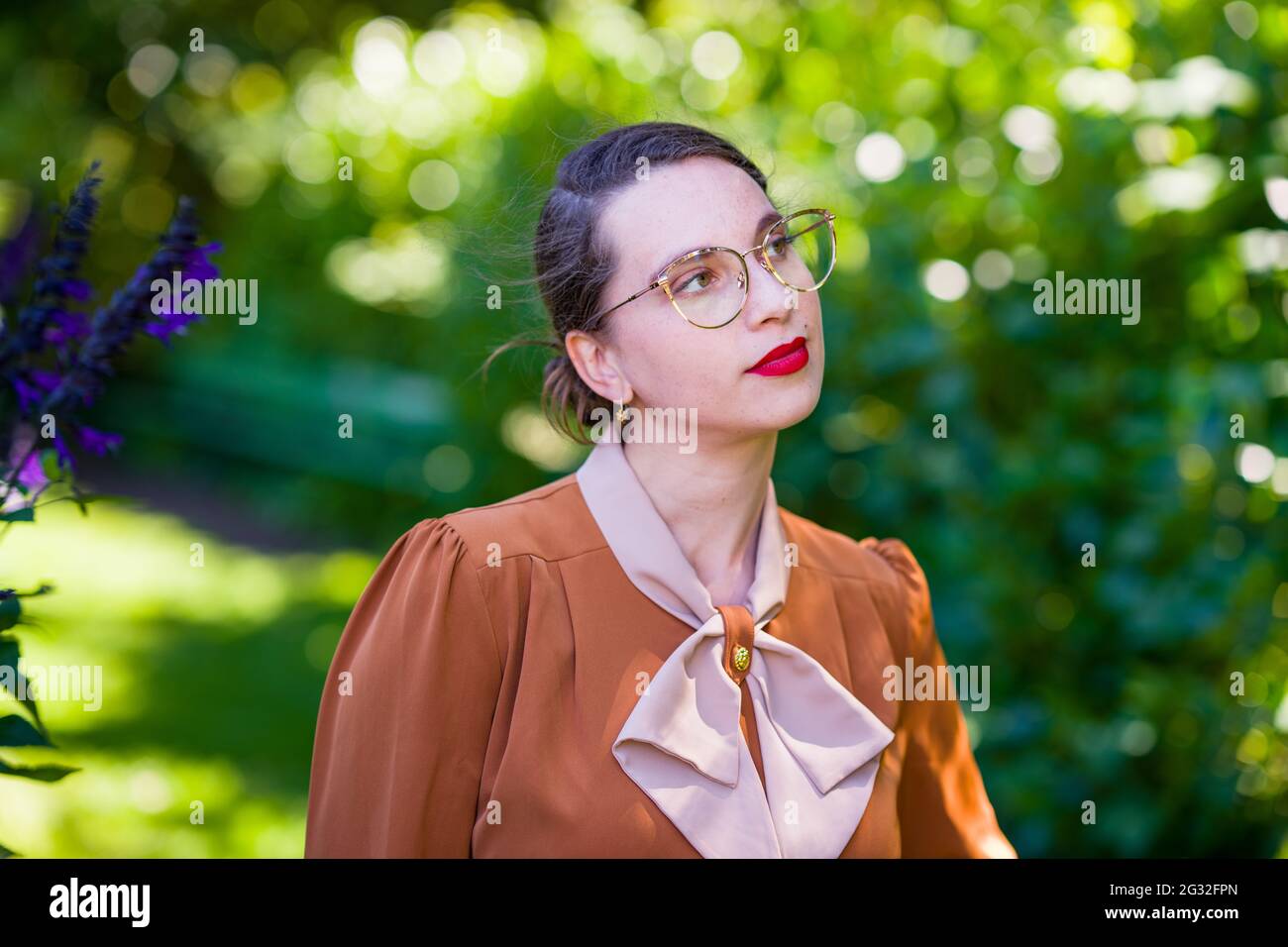 Young Intellectual Woman Dressed in 1940s Clothing In a Garden Stock ...