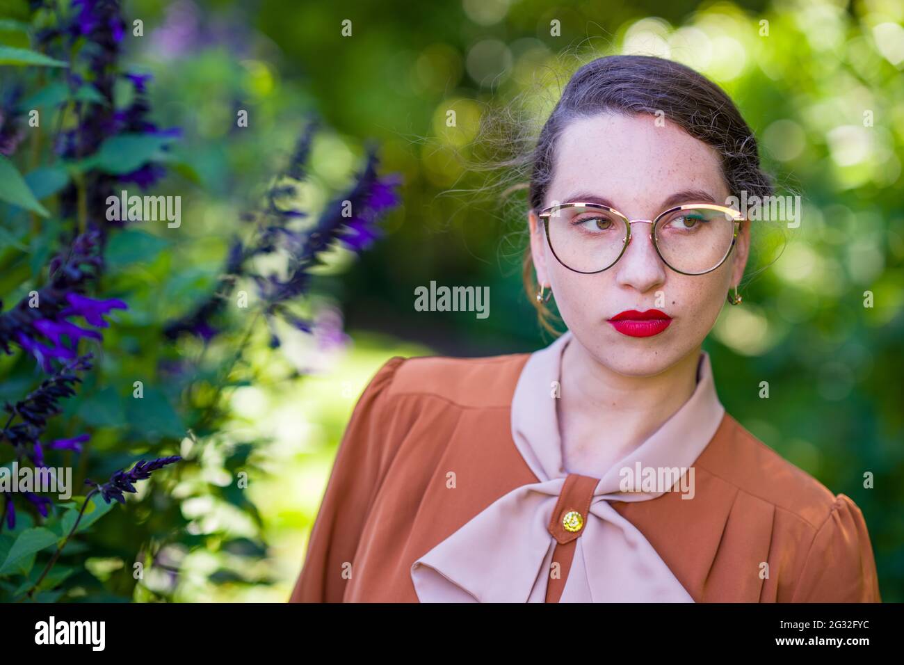Young Intellectual Woman Dressed in 1940s Clothing In a Garden Stock ...