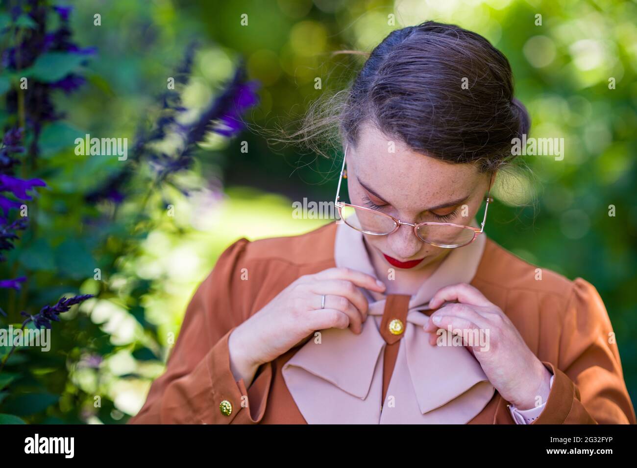 Young Intellectual Woman Dressed in 1940s Clothing In a Garden Stock ...