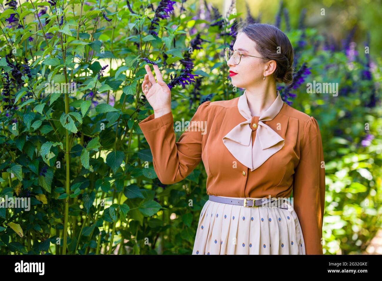 Young Intellectual Woman Dressed in 1940s Clothing In a Garden Stock ...