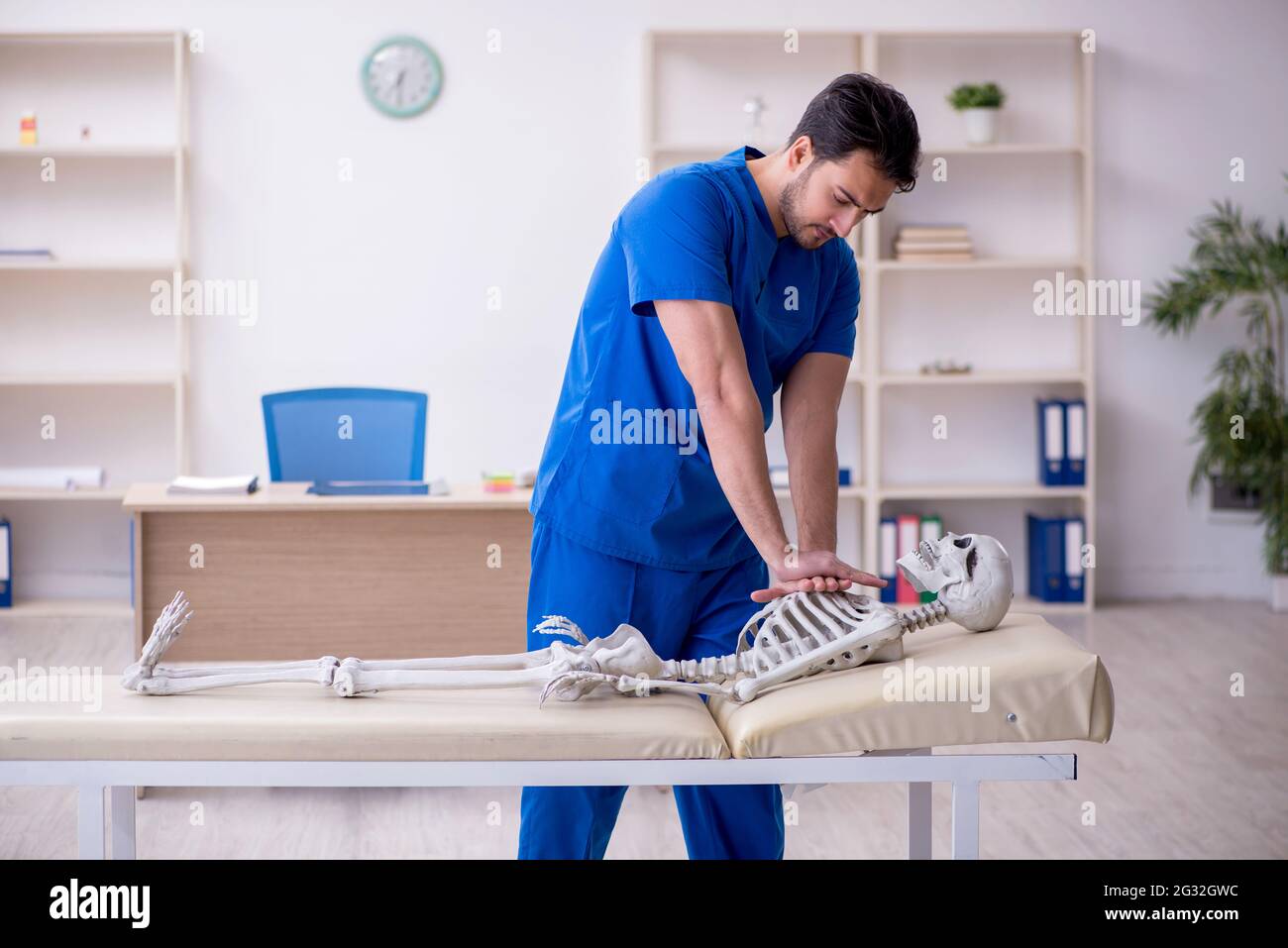 Doctor osteopath explaining human skeleton hi-res stock photography and ...