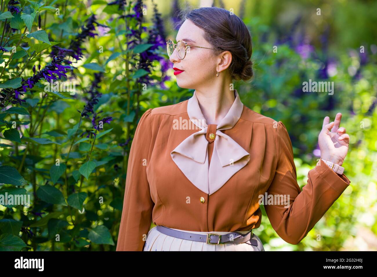 Young Intellectual Woman Dressed in 1940s Clothing In a Garden Stock ...
