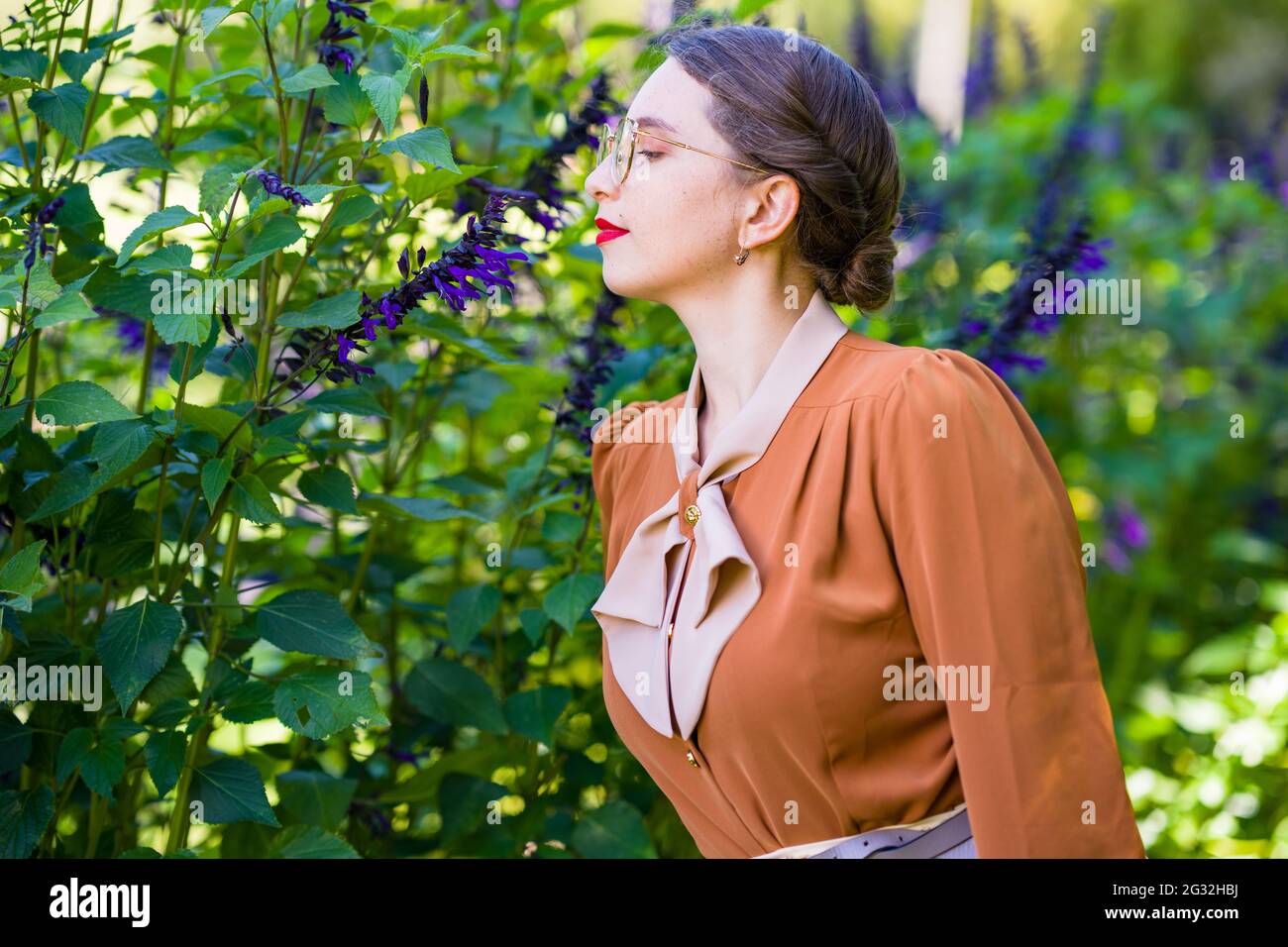 Young Intellectual Woman Dressed in 1940s Clothing In a Garden Stock ...