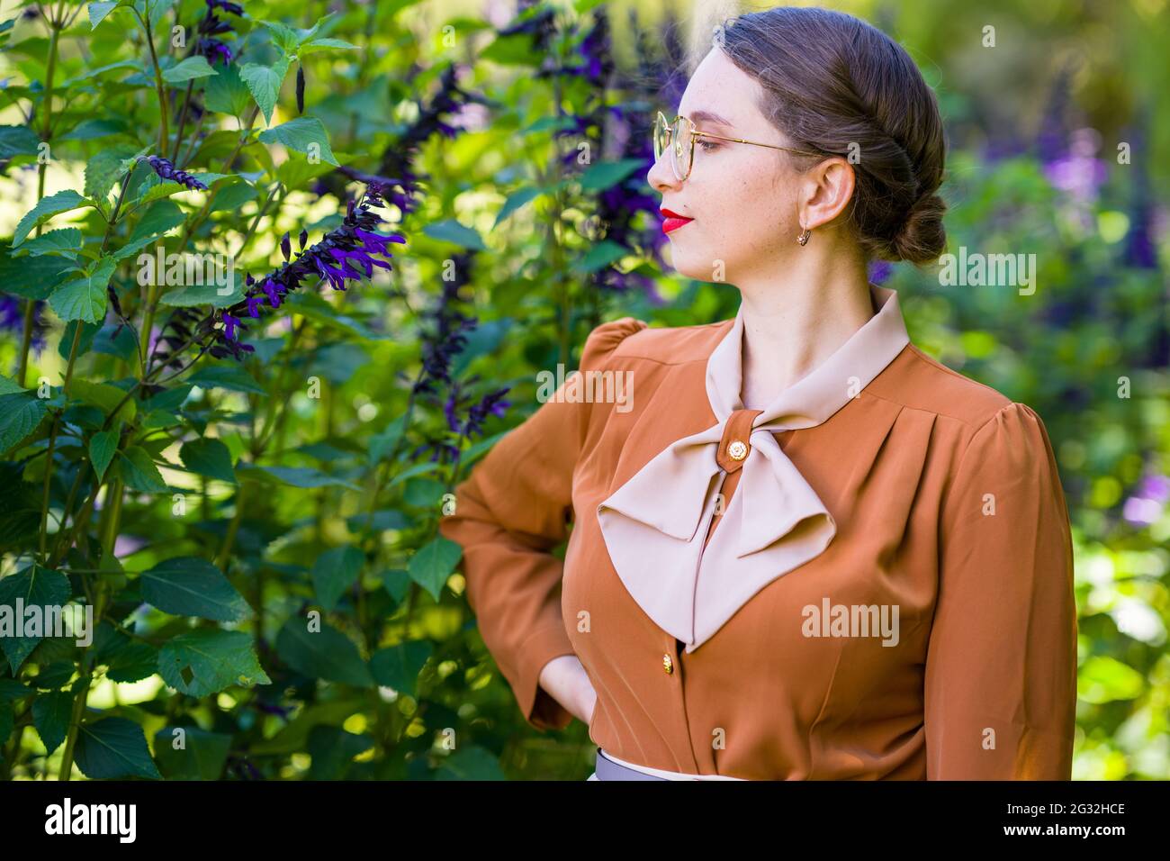Young Intellectual Woman Dressed in 1940s Clothing In a Garden Stock ...