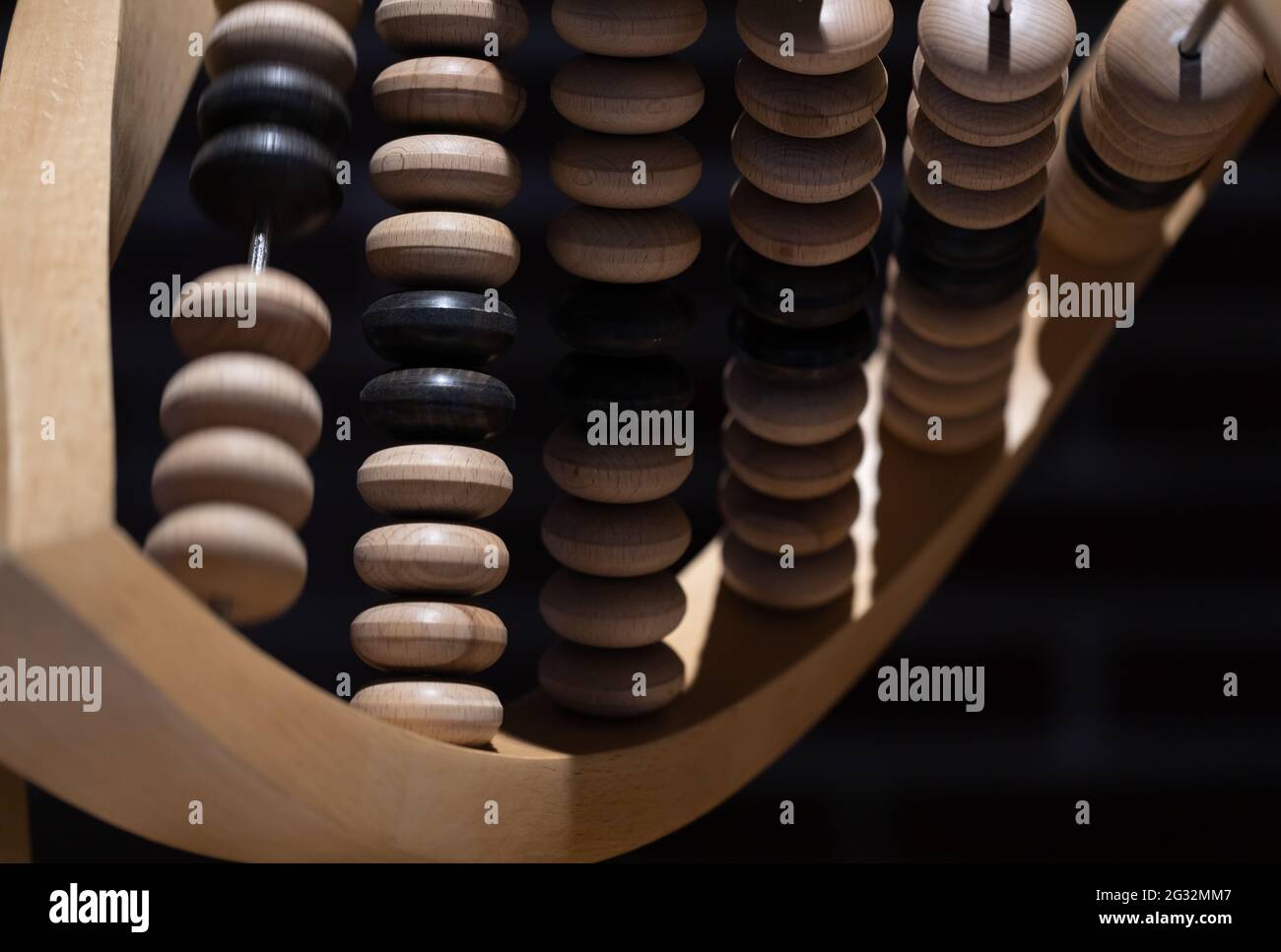 wooden curved abacus on a black background. Close-up Stock Photo - Alamy