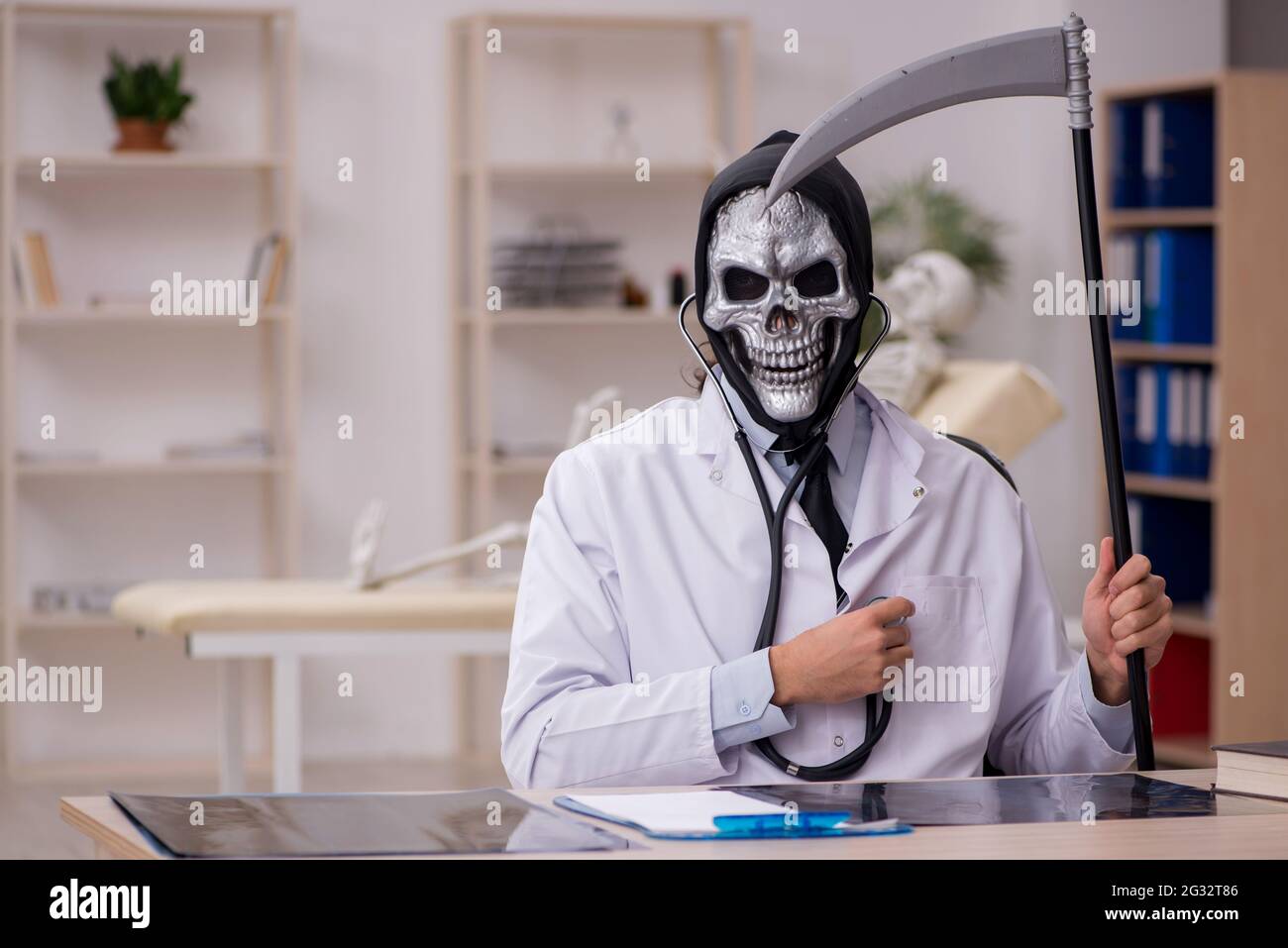 Reaper grim doctor examining skeleton patient in the clinic Stock Photo ...