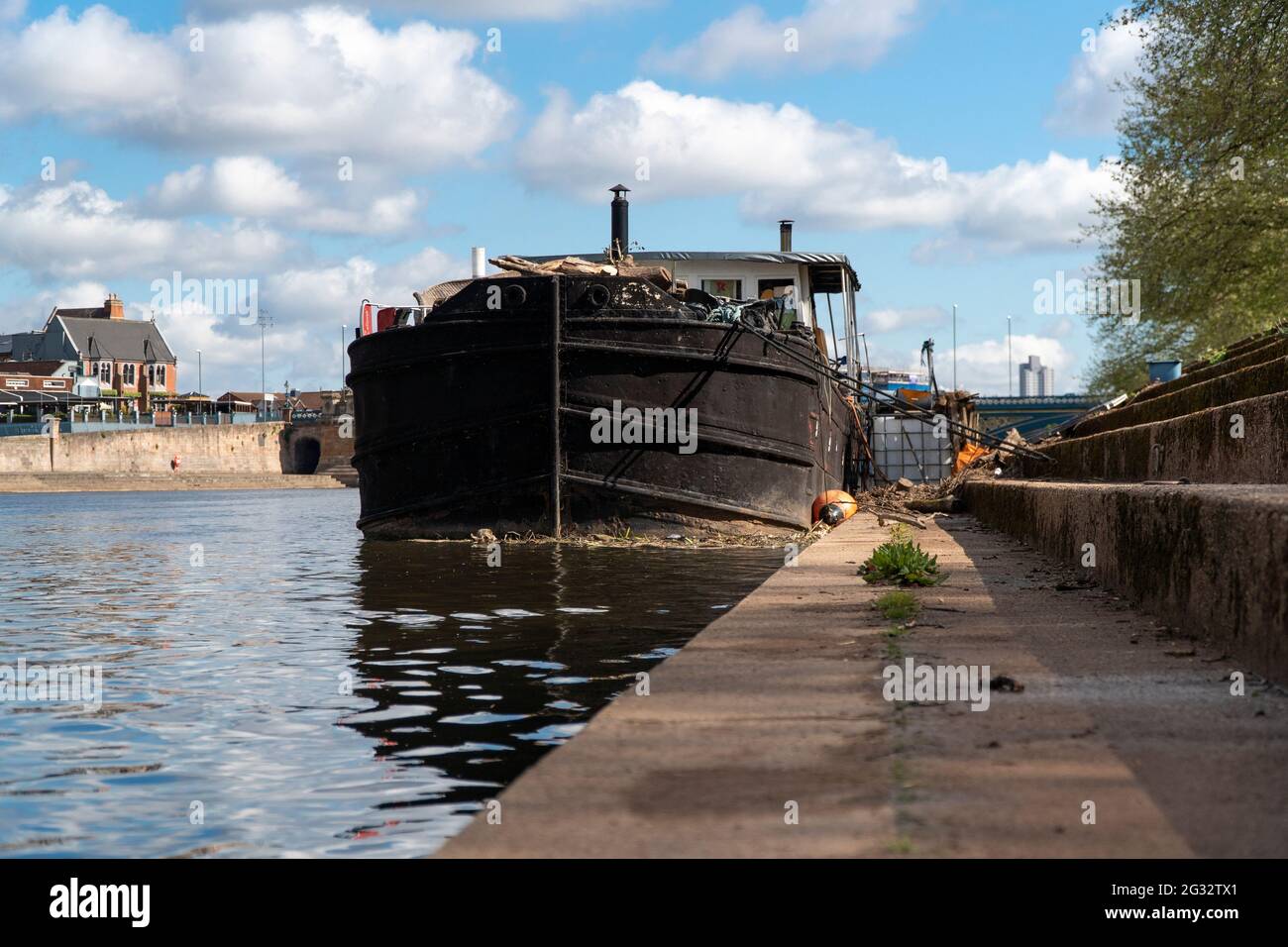 Big river barge moored on concrete steps Stock Photo - Alamy