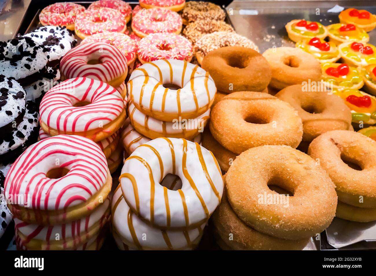 Tasty sweets in window of confectionery store. Fresh pastries, donuts ...