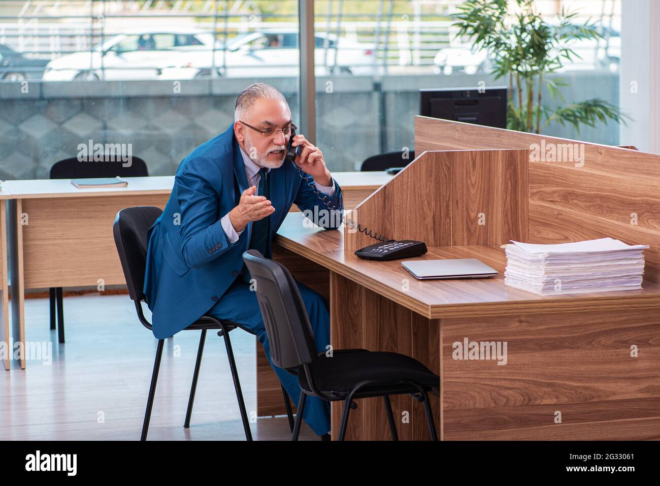 Old employee working in the office Stock Photo - Alamy
