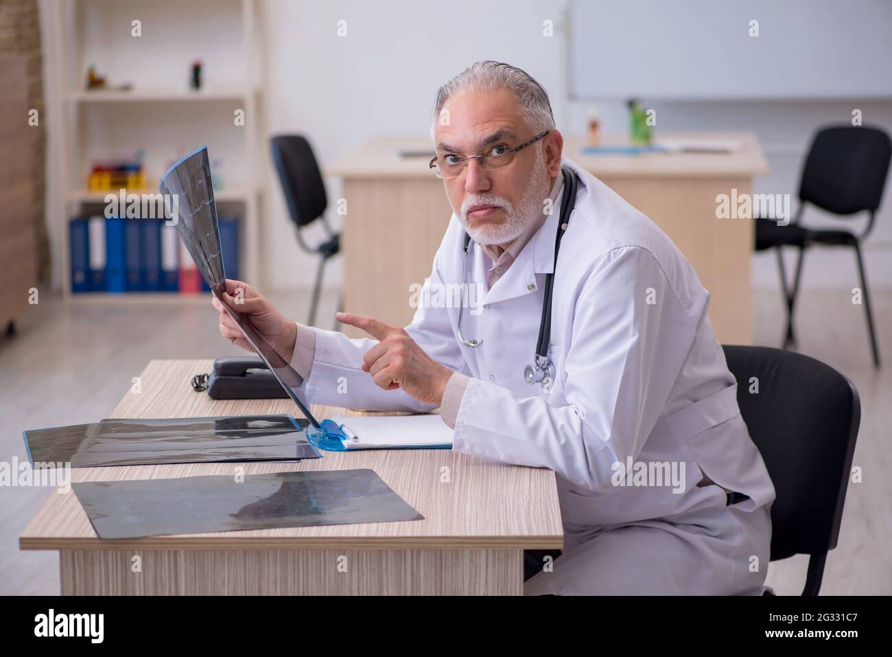 Old doctor radiologist working in the clinic Stock Photo - Alamy