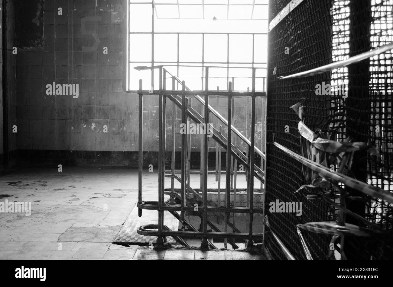 A grayscale inside of an abandoned dirty building Stock Photo - Alamy