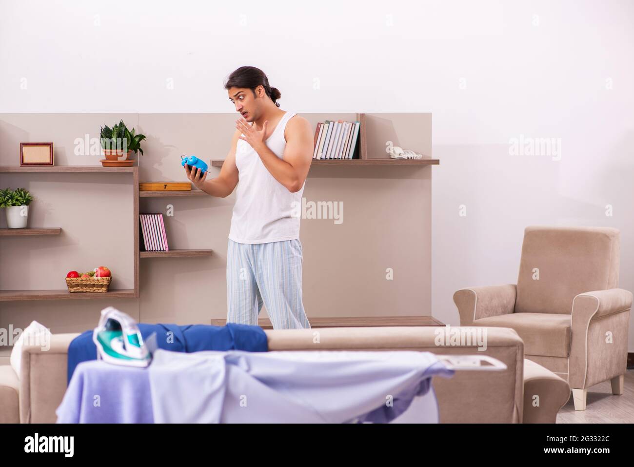 Young employee getting up late at home Stock Photo - Alamy
